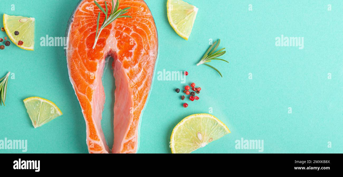Uncooked raw fresh fish salmon steak top view on blue background with ...