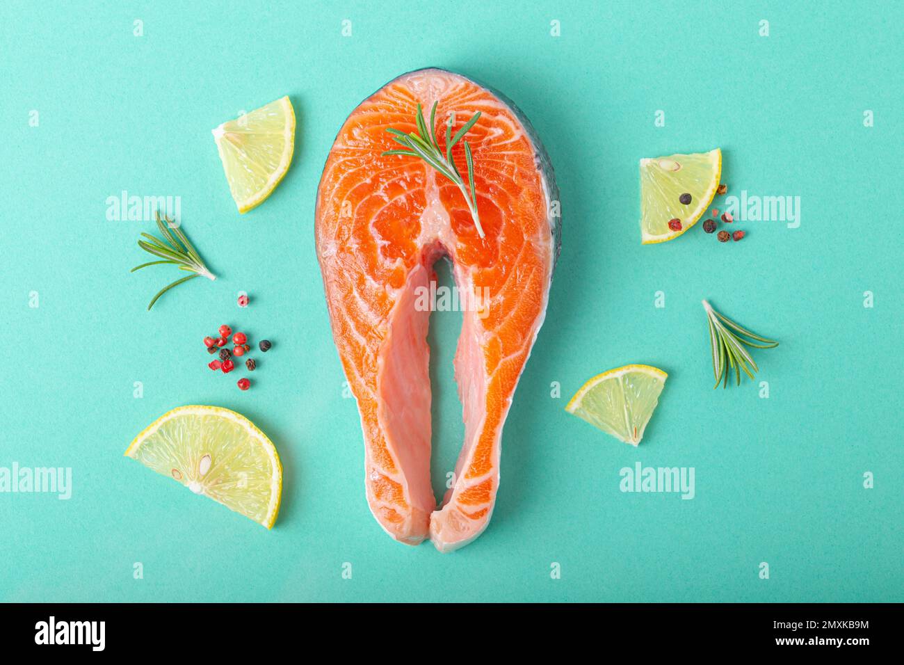 Uncooked raw fresh fish salmon steak top view on blue background with ...