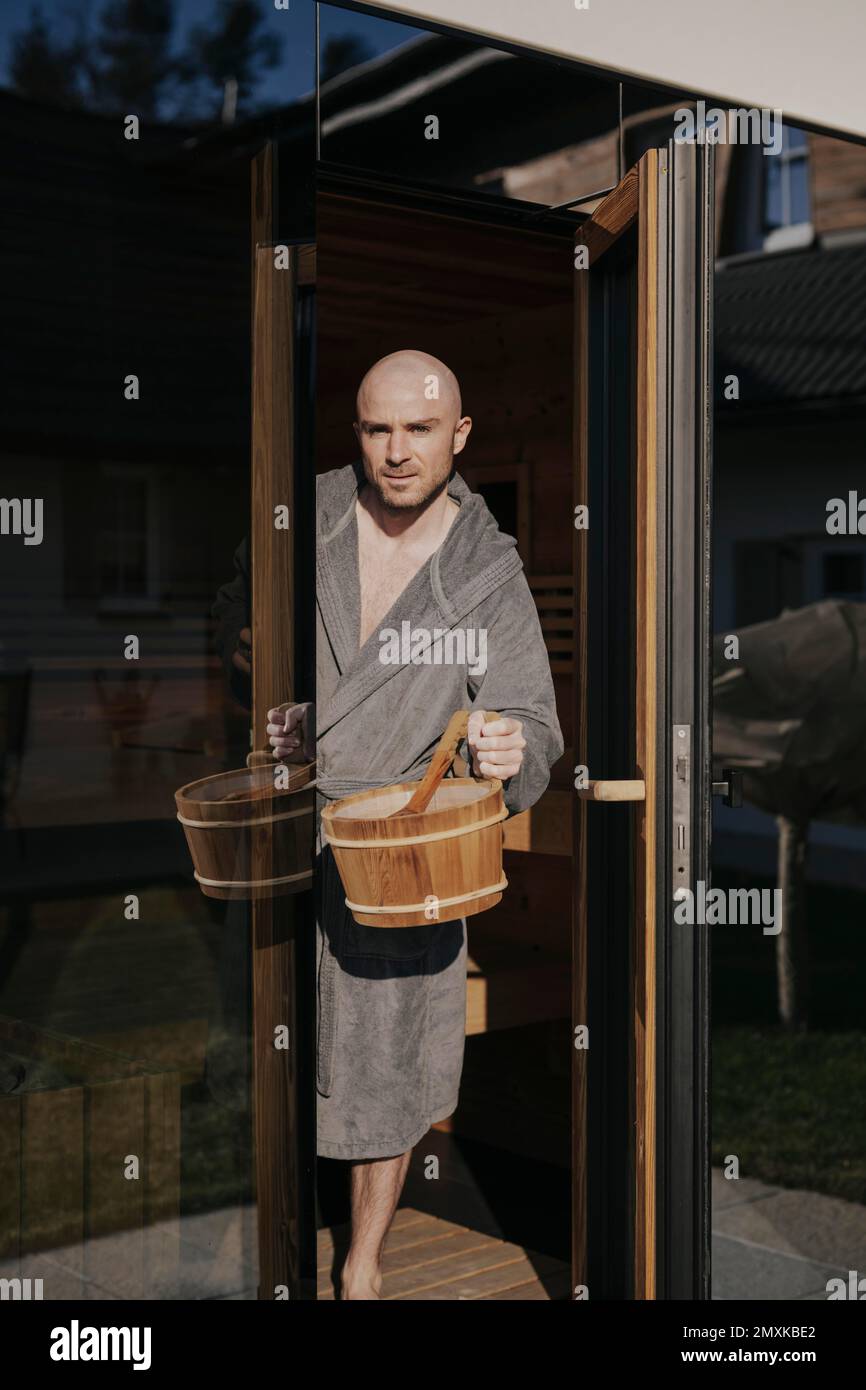Man with infusion tub in sauna Stock Photo - Alamy