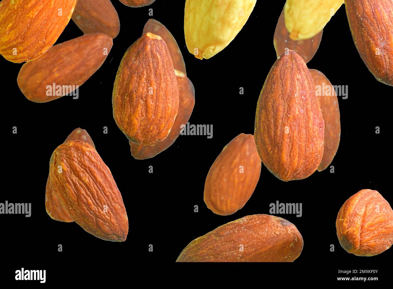 Almonds falling in black hi-res stock photography and images - Alamy