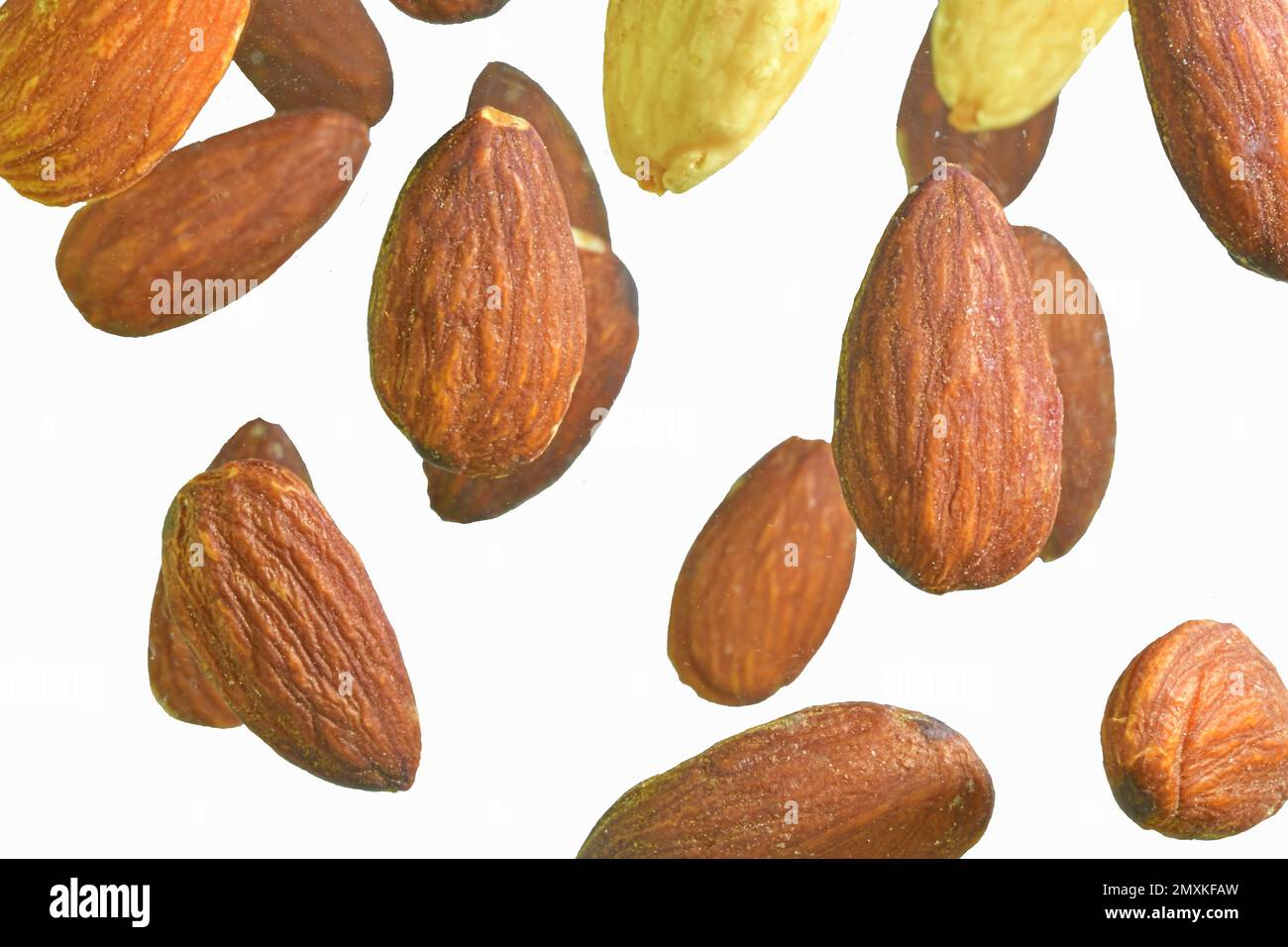 Falling almond isolated on a white background, selective focus. Almond ...