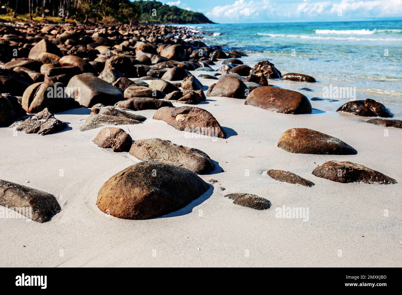 Stone on beach at the sea with blue sky Stock Photo - Alamy