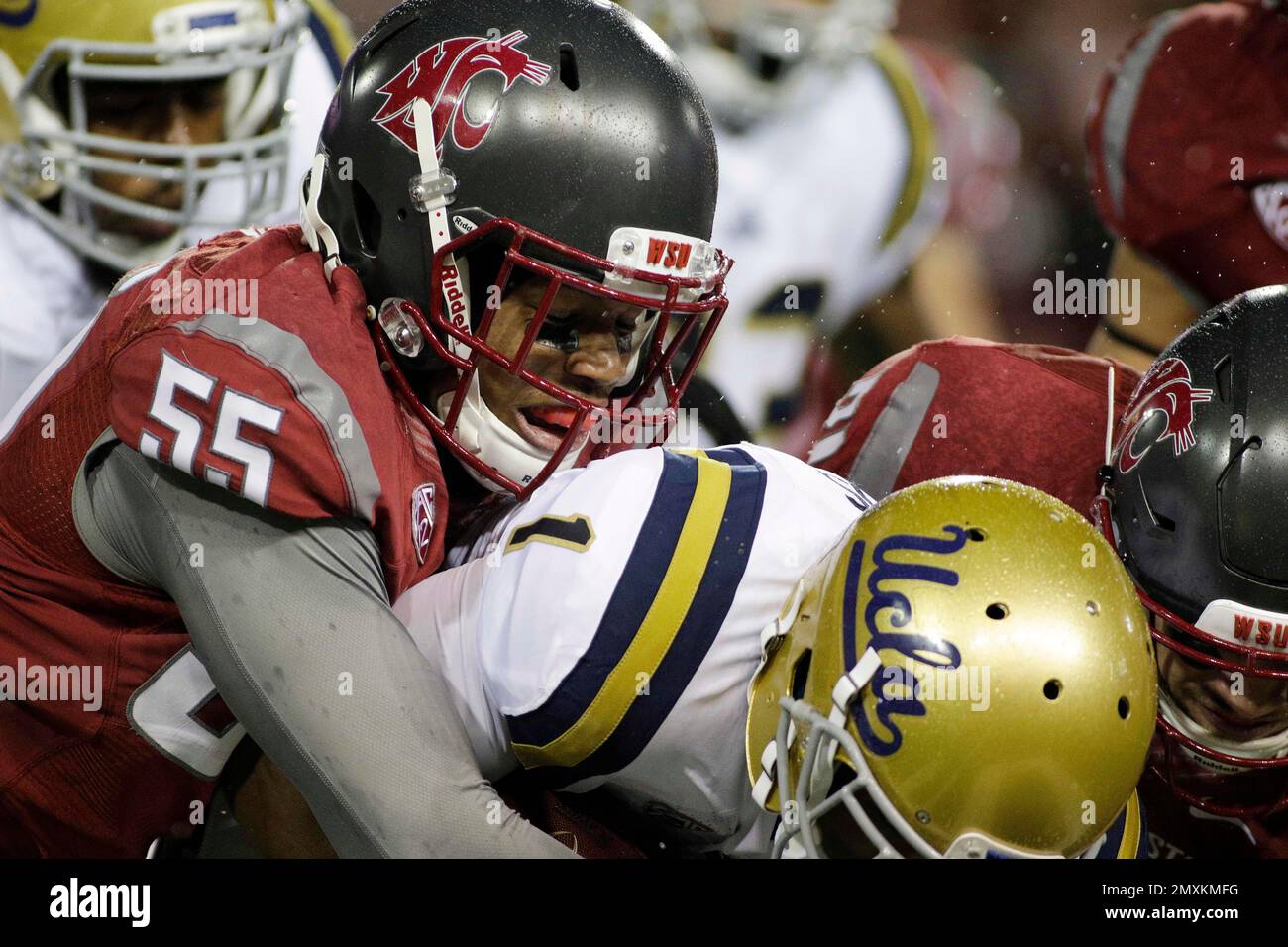 Washington State linebacker Derek Moore (55) brings down UCLA wide ...