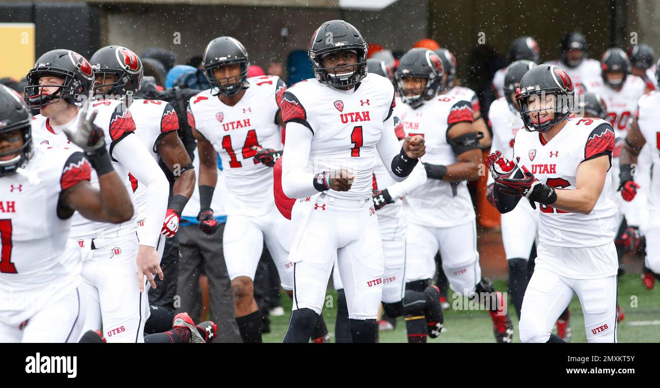 Players from the Utah Utes come onto the field before an NCAA college ...