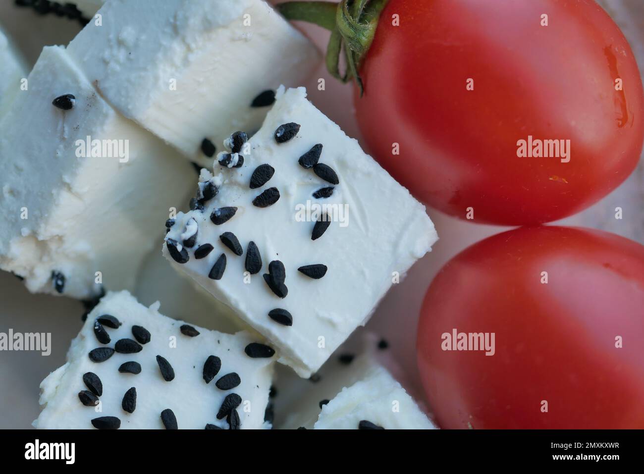greek feta cubes with tomato diced soft cheese on plate Stock Photo - Alamy