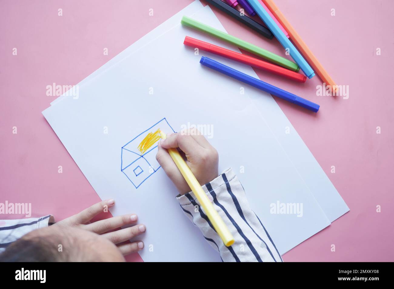 top view of child girl drawing on paper sitting on floor Stock Photo ...