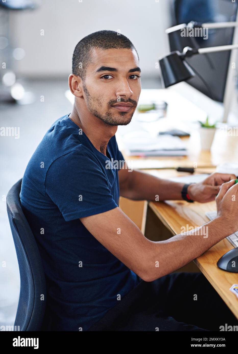 Make creativity a job. Portrait of a young designer at work on his ...