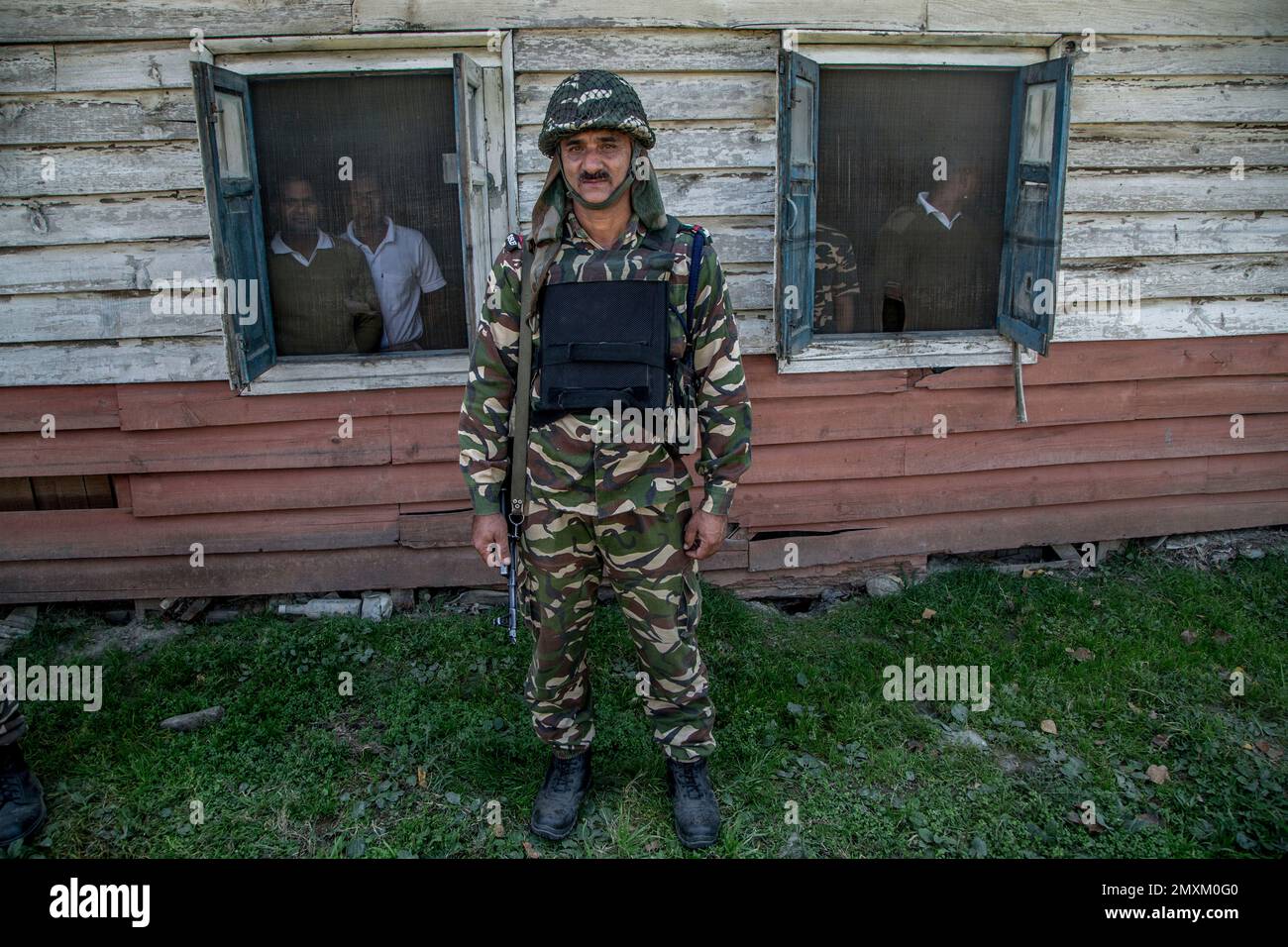 An Indian paramilitary soldier watches a wreath laying ceremony of ...