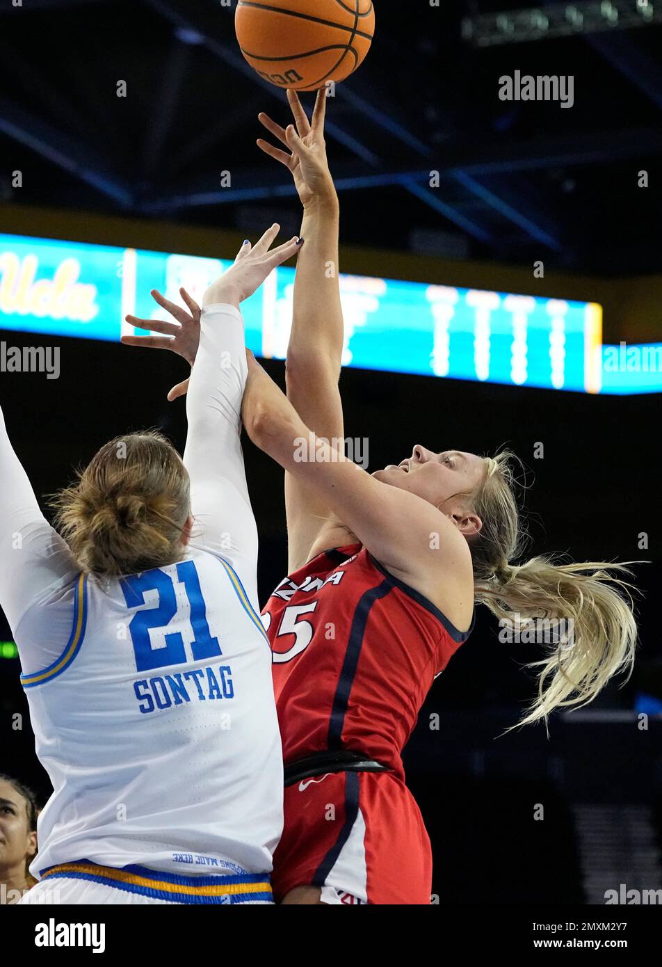 Arizona forward Cate Reese, right, shoots as UCLA forward Lina Sontag ...