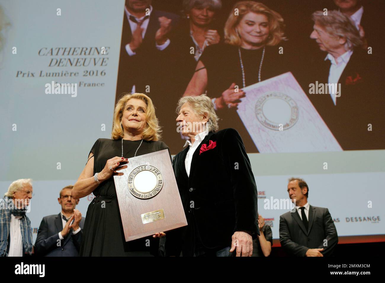 French actress Catherine Deneuve holds her Lumiere Award given by ...