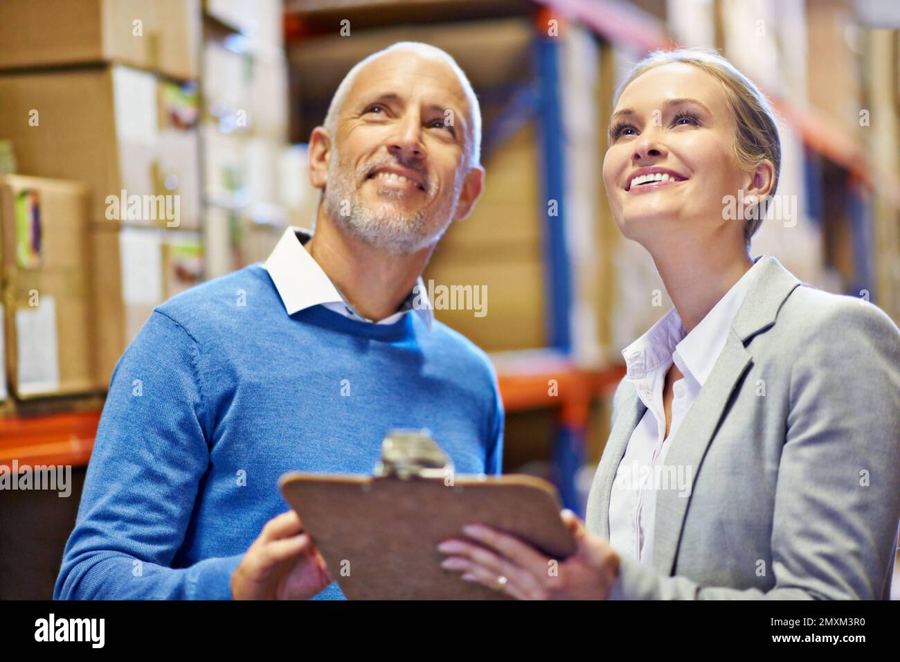 Logistics is their thing. two people doing an inventory check in a ...