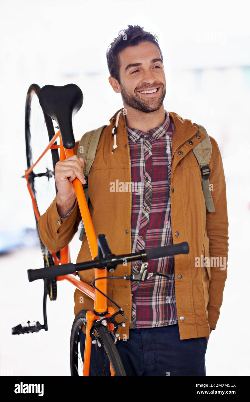 Just me and my trusty bike. a handsome young man walking with his ...