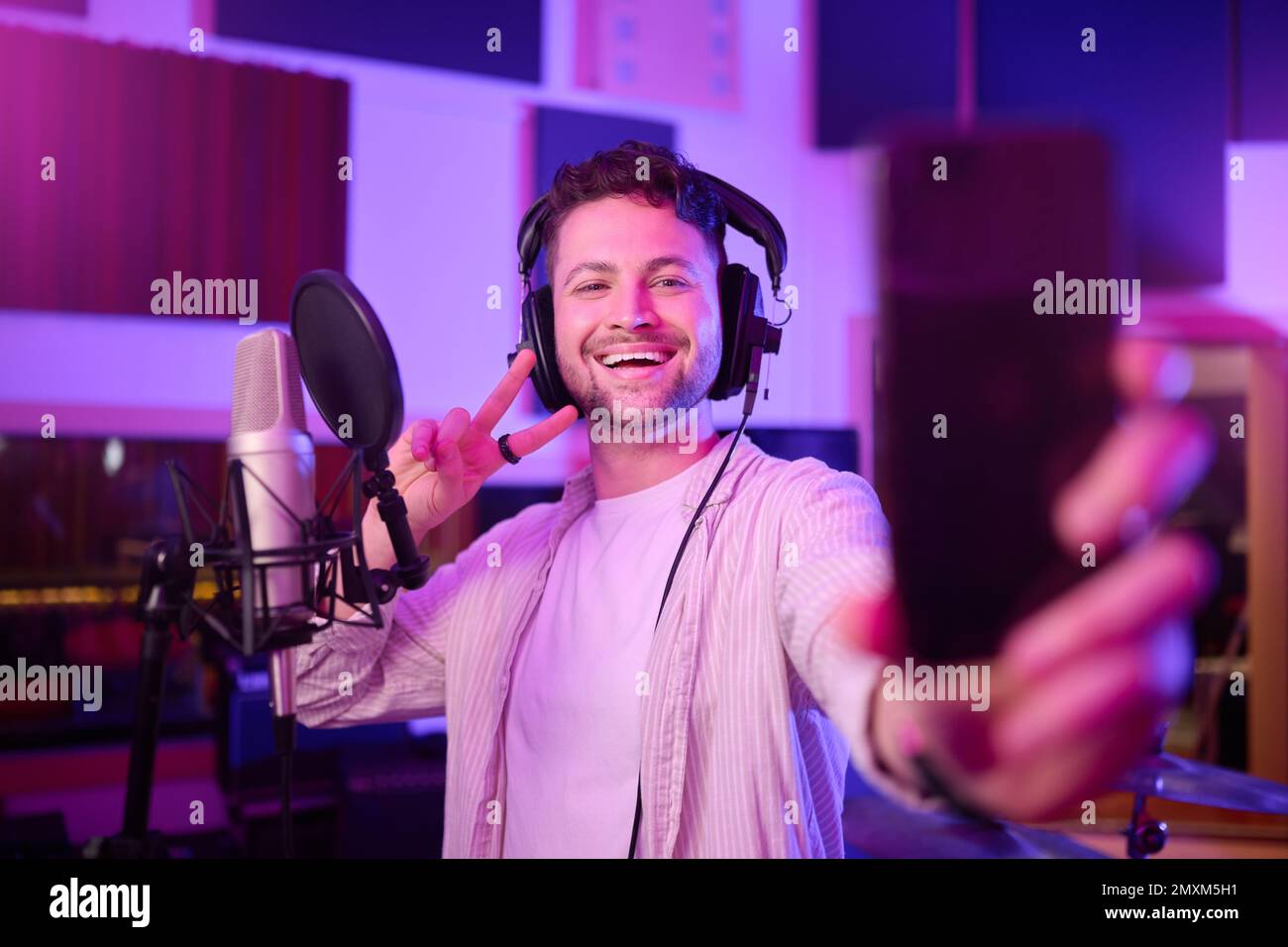 Singer in recording studio, selfie and portrait with peace hand sign ...