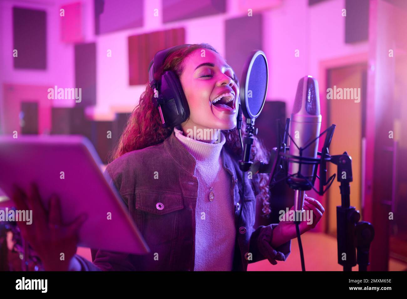 Technology, singing or woman on neon microphone, music studio lyrics or ...