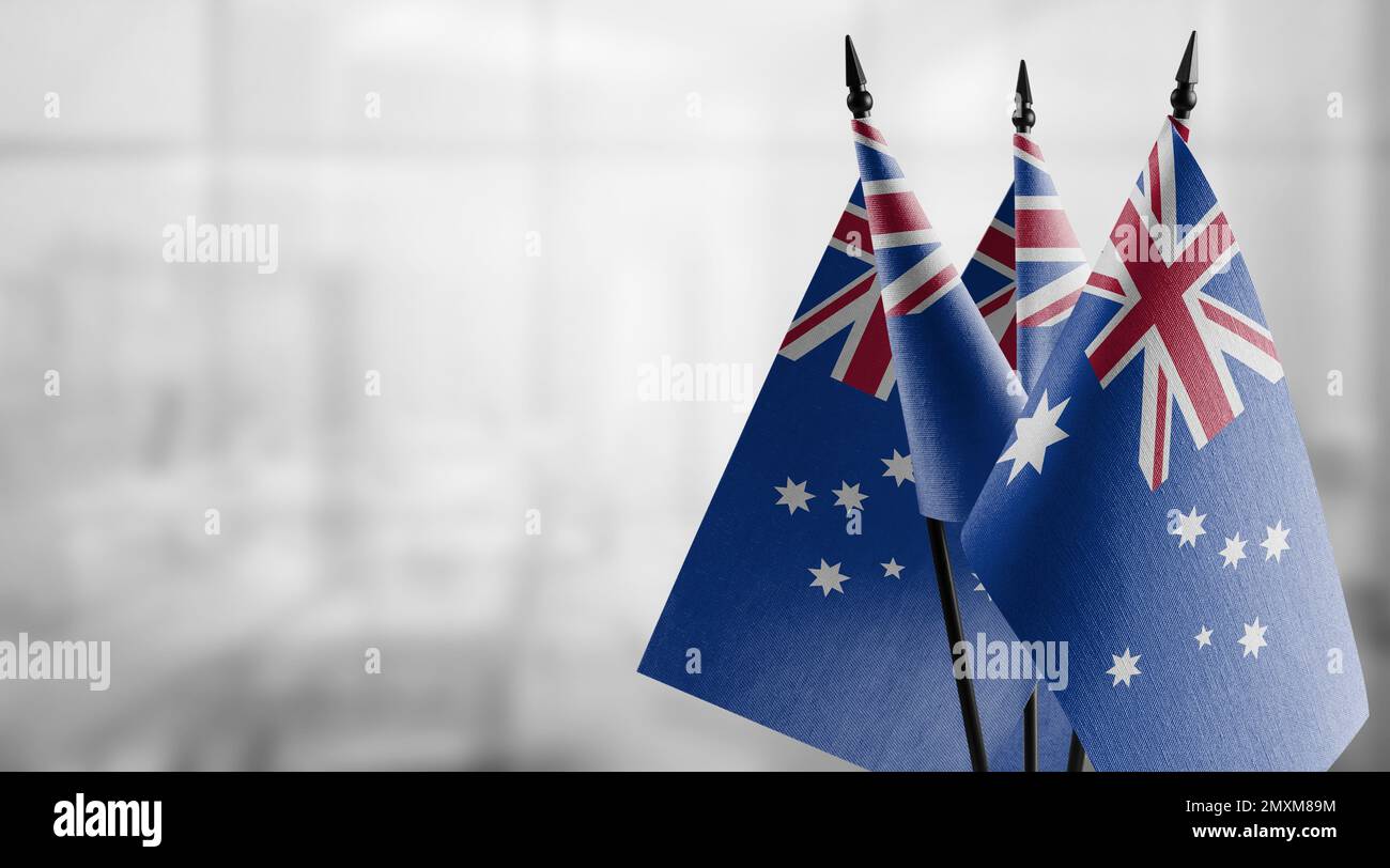 Small flags of the Australia on an abstract blurry background Stock ...