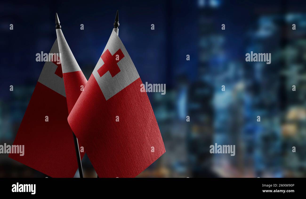 Small flags of the Tonga on an abstract blurry background Stock Photo ...