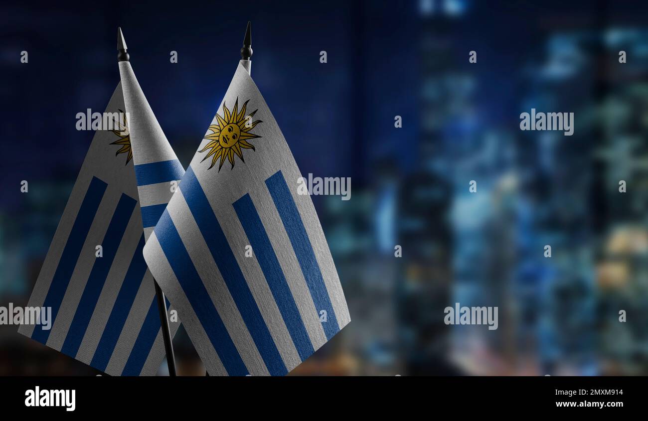 Small flags of the Uruguay on an abstract blurry background Stock Photo ...