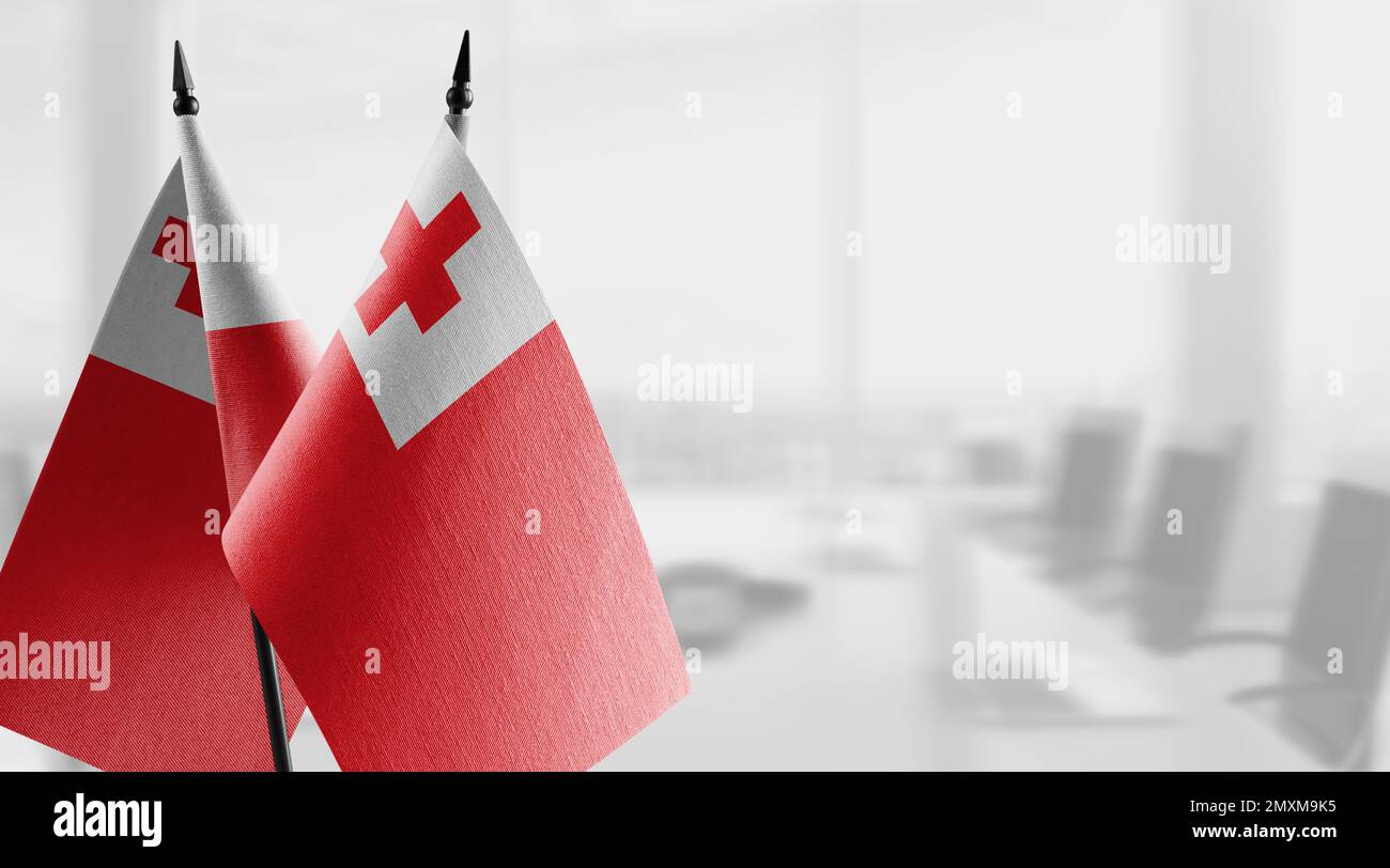 Small flags of the Tonga on an abstract blurry background Stock Photo ...