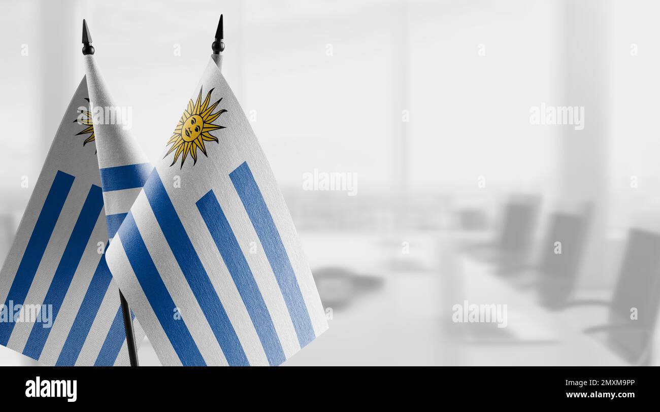 Small flags of the Uruguay on an abstract blurry background Stock Photo ...