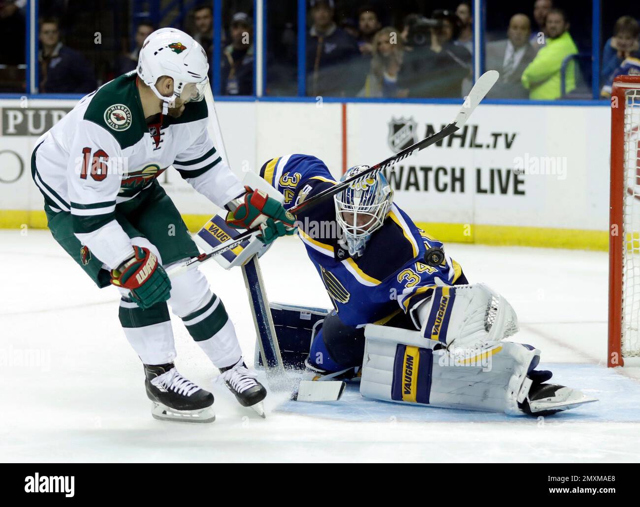 St. Louis Blues goalie Jake Allen, right, deflects a shot from ...