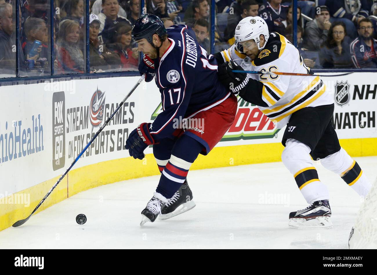 Columbus Blue Jackets' Brandon Dubinsky, left, tries to control the ...