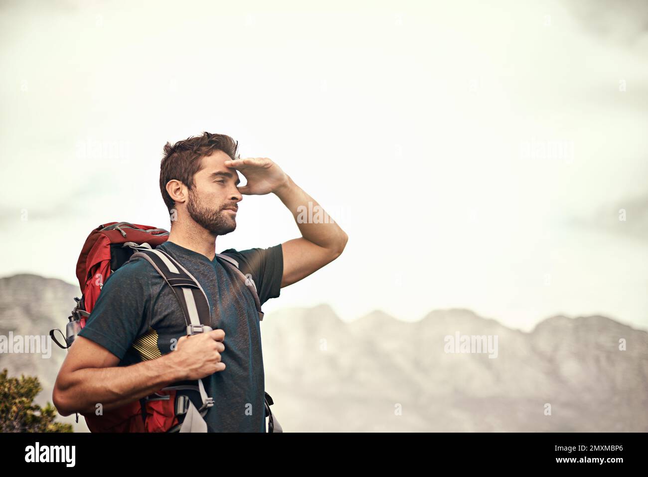 Admiring the beauty of nature along the way. a young man looking at the ...