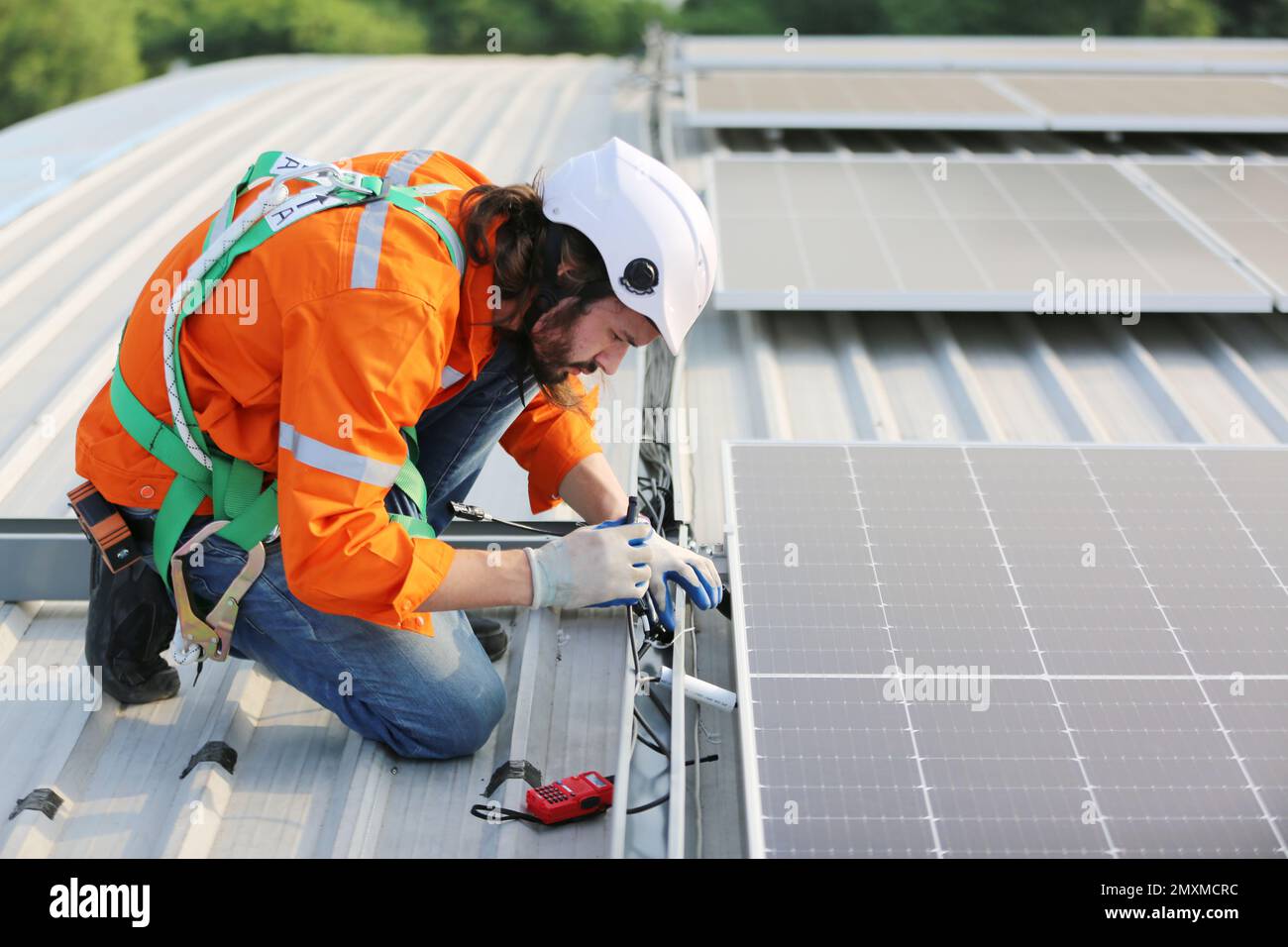 engineers installing solar panels on roof. Male engineers walking along ...