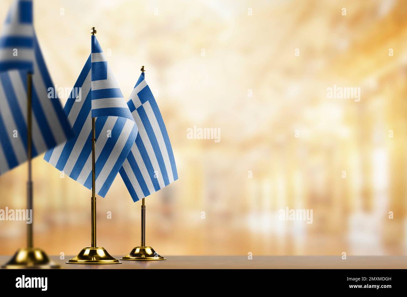 Small flags of the Greece on an abstract blurry background Stock Photo ...