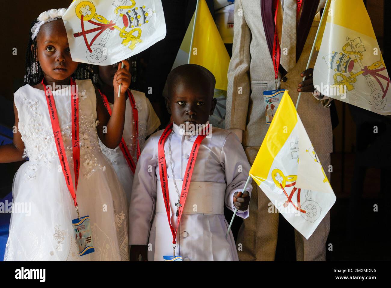 Children hold Vatican flags as they wait for the arrival of Pope ...