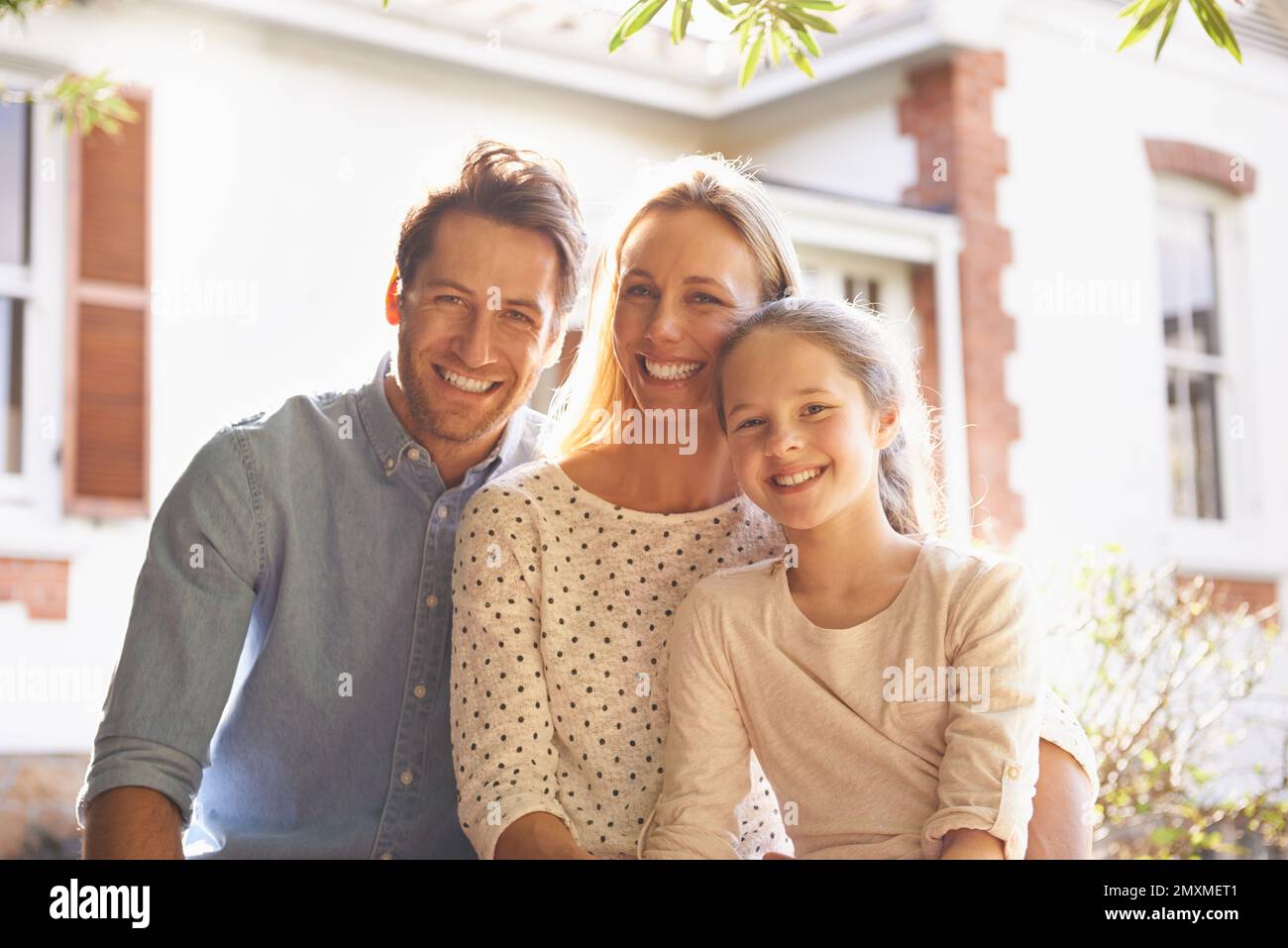 A truly happy family. A portrait of a happy family sitting outside of ...