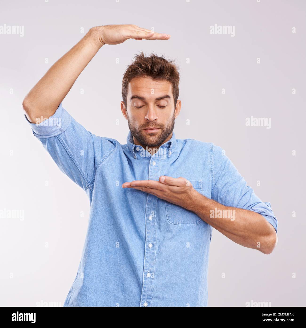 It needs to be about this big. Studio shot of a handsome man holding an ...