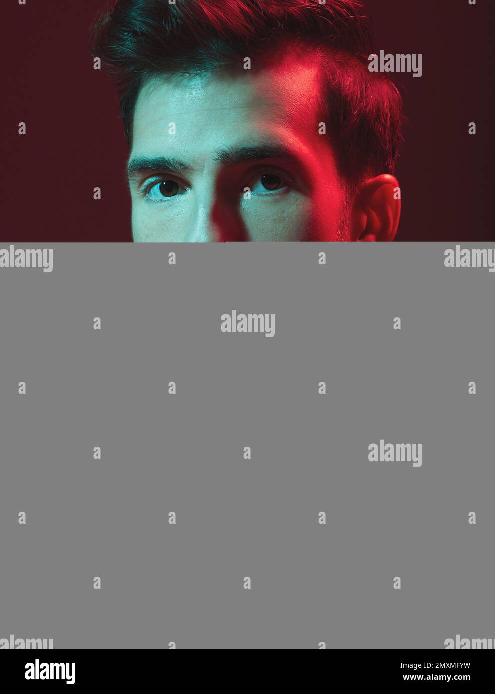 Face portrait, fashion and man in studio with red light for clothes ...