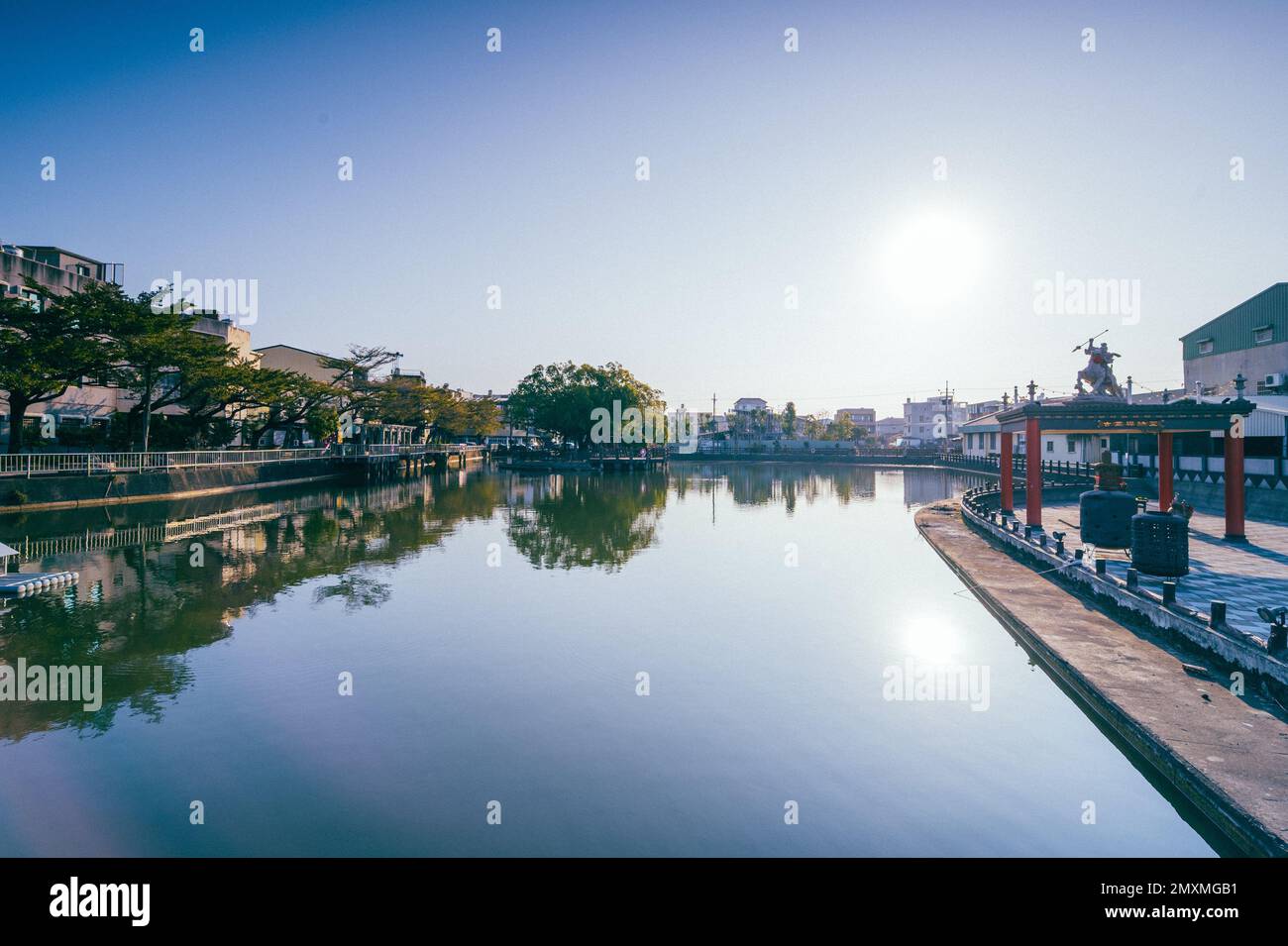 The temple, the blue lake and the green trees make a beautiful rural ...