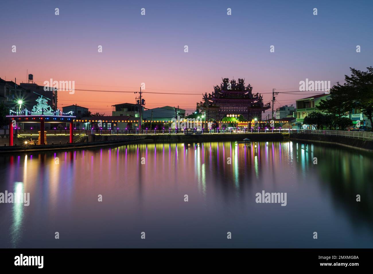 The temple, the blue lake and the green trees make a beautiful rural ...