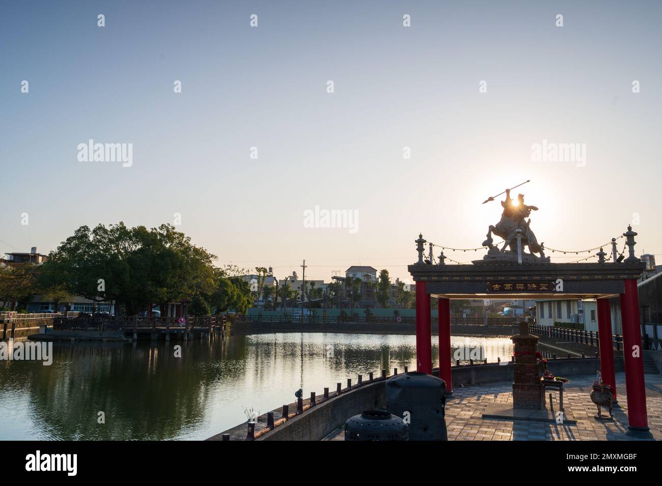 The temple, the blue lake and the green trees make a beautiful rural ...