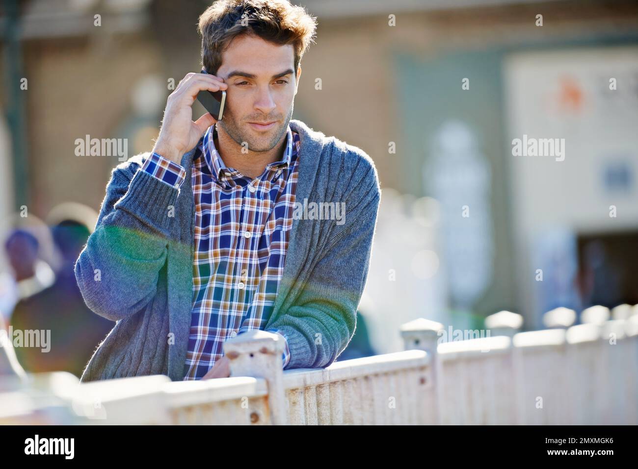 Making an important call. a handsome young man making a call on his ...
