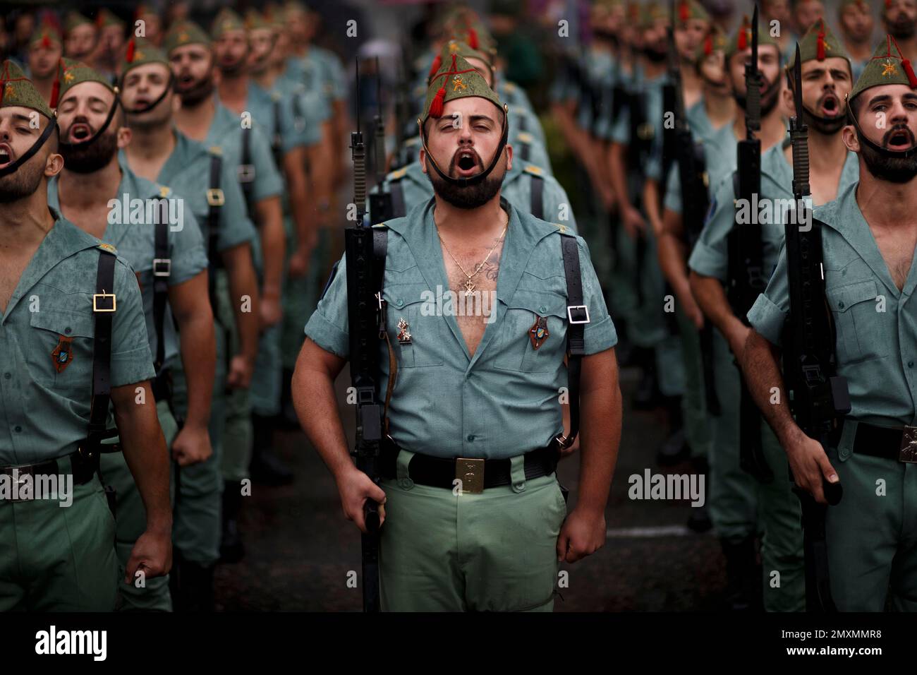 Members of La Legion, an elite unit of the Spanish Army, sing during a ...
