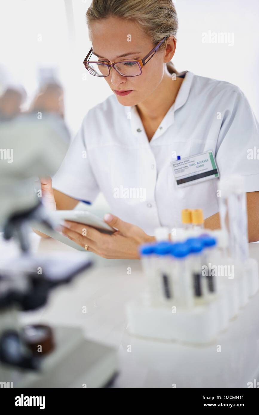 Recording her data for further analysis. A young scientist working on a ...