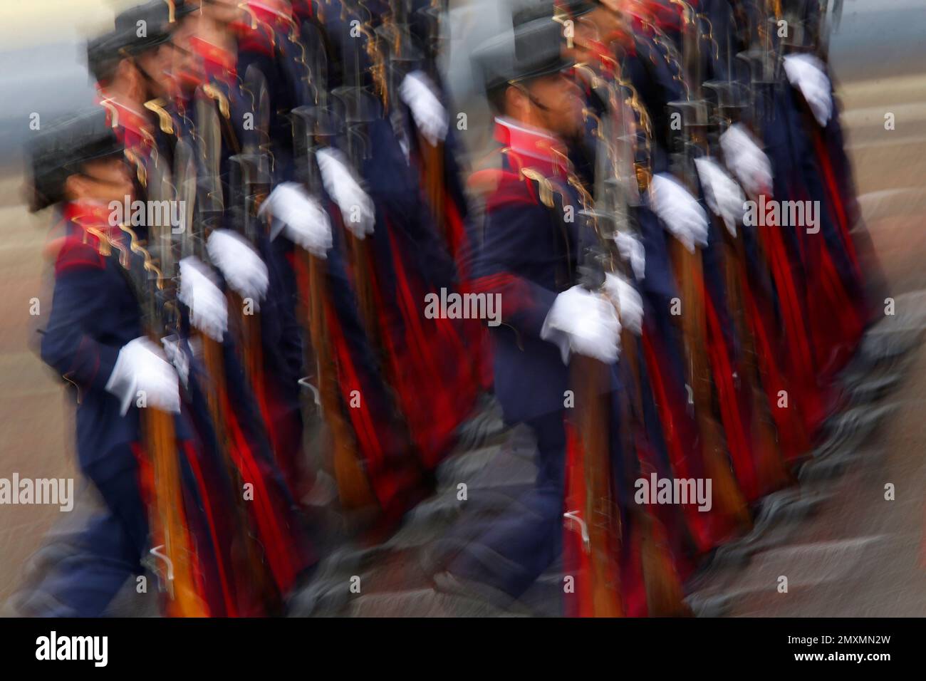 In this photo taken with a slow shutter speed, Spanish soldiers march ...