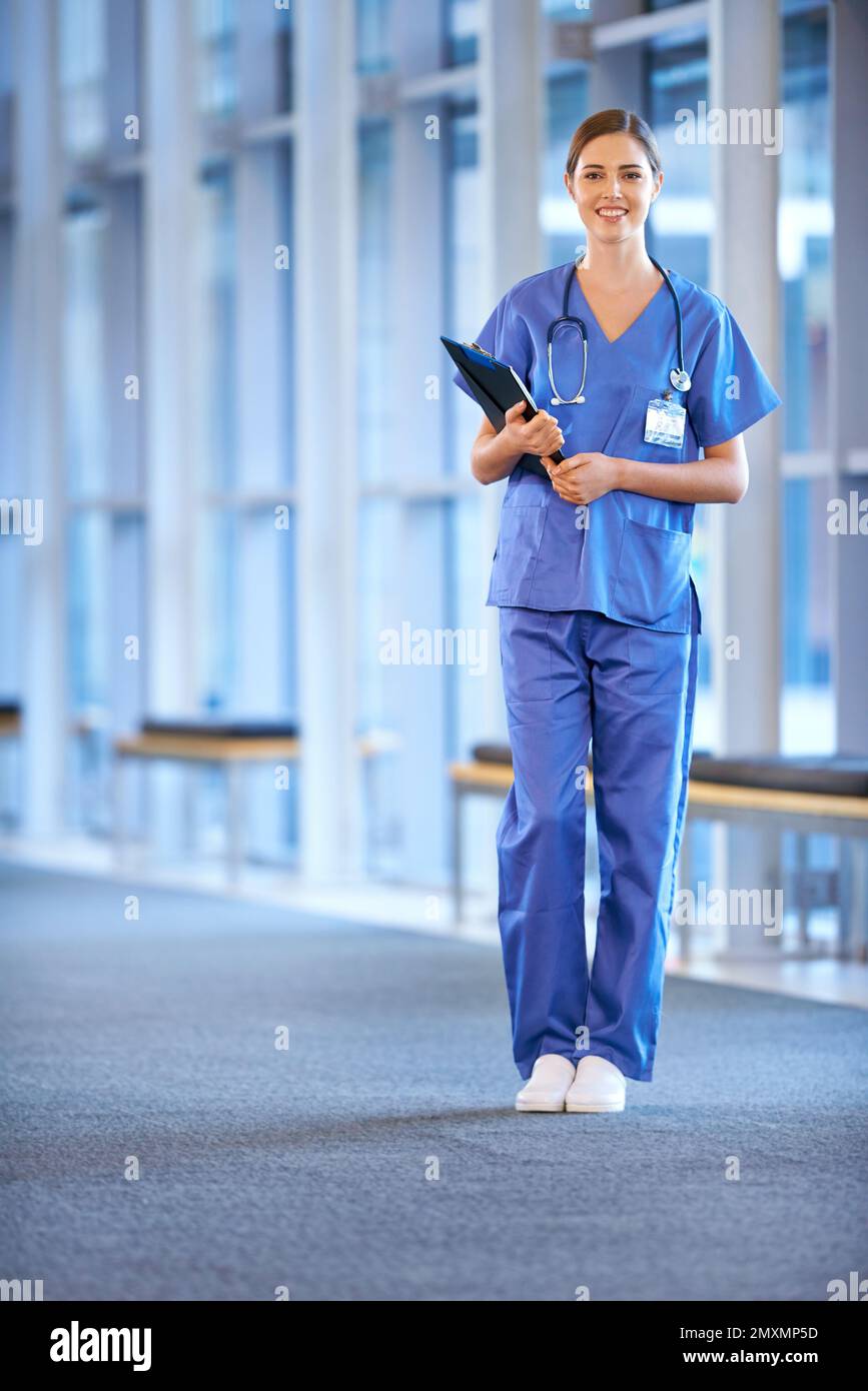 Getting her rounds done. Portrait of a happy young doctor walking down ...