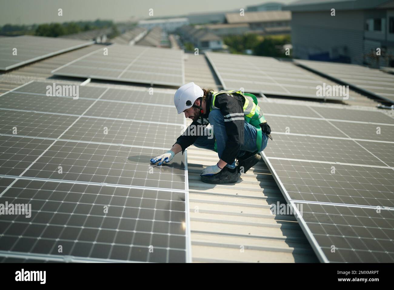 engineers installing solar panels on roof. Male engineers walking along ...