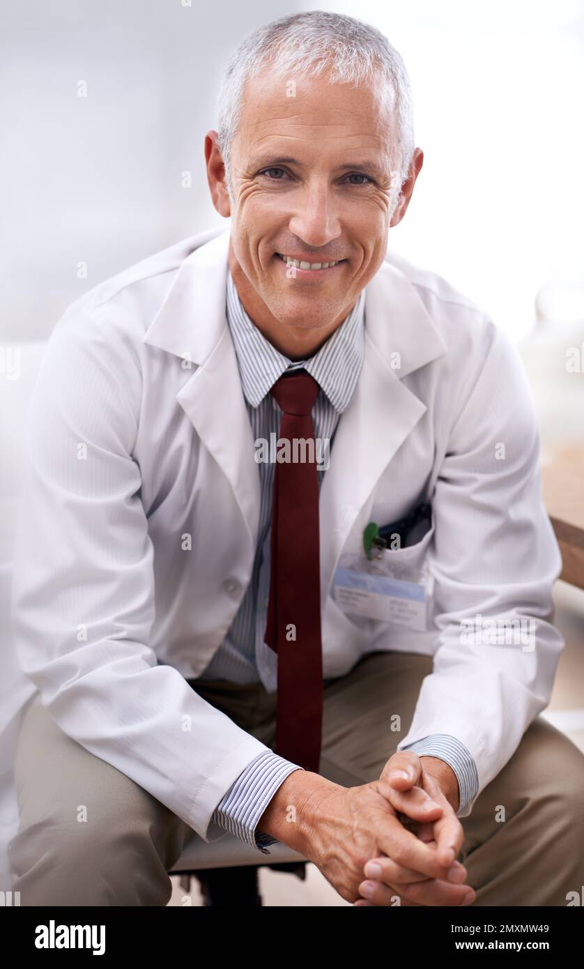 Confident in his medical skills. Portrait of a male doctor sitting in ...