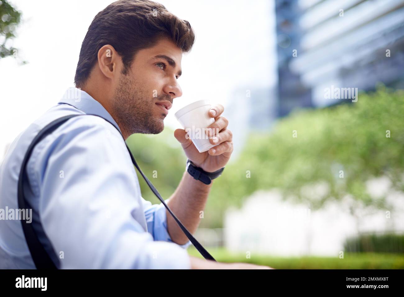 A quick coffee to start the day. A handsome young businessman drinking ...