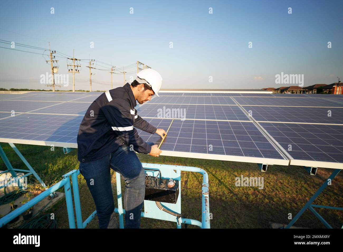 engineers installing solar panels on roof. Male engineers walking along ...