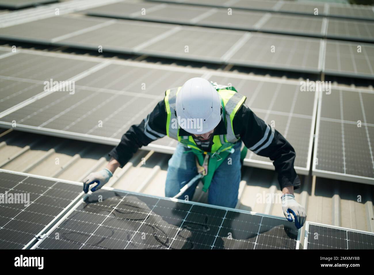 engineers installing solar panels on roof. Male engineers walking along ...