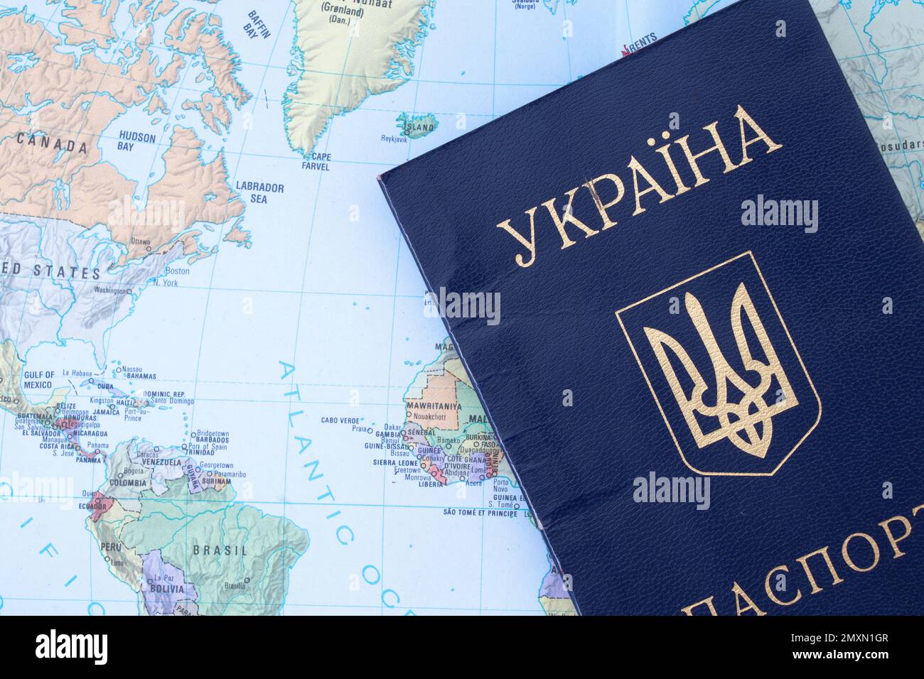 Ukraine passport and a geographical map of the planet Stock Photo - Alamy