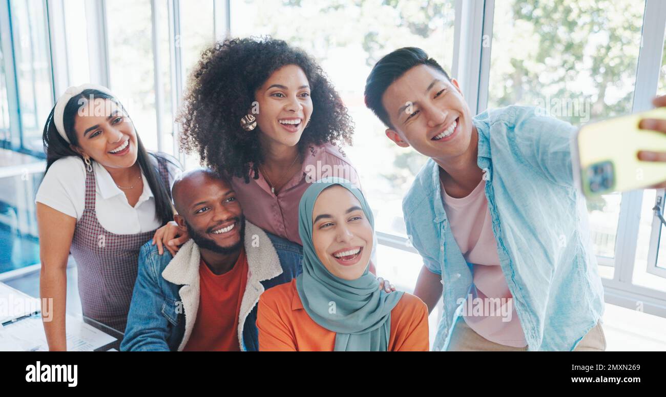 Phone, team building or happy employees take a selfie in an office room ...