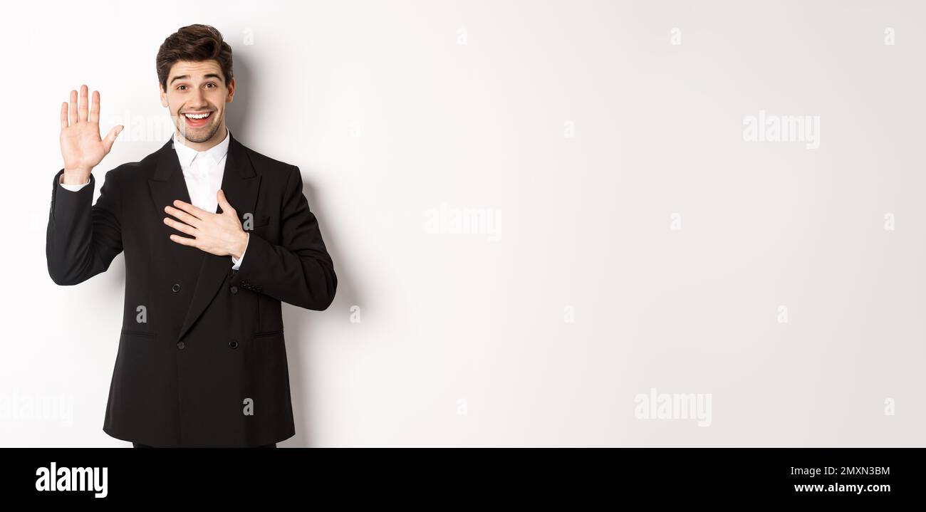 Image of handsome smiling guy telling the truth, raising on arm to ...