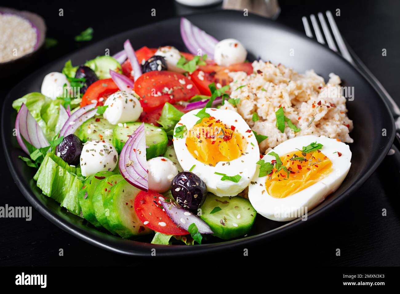 Healthy breakfast. Greek inspired savory oatmeal with fresh cucumber ...