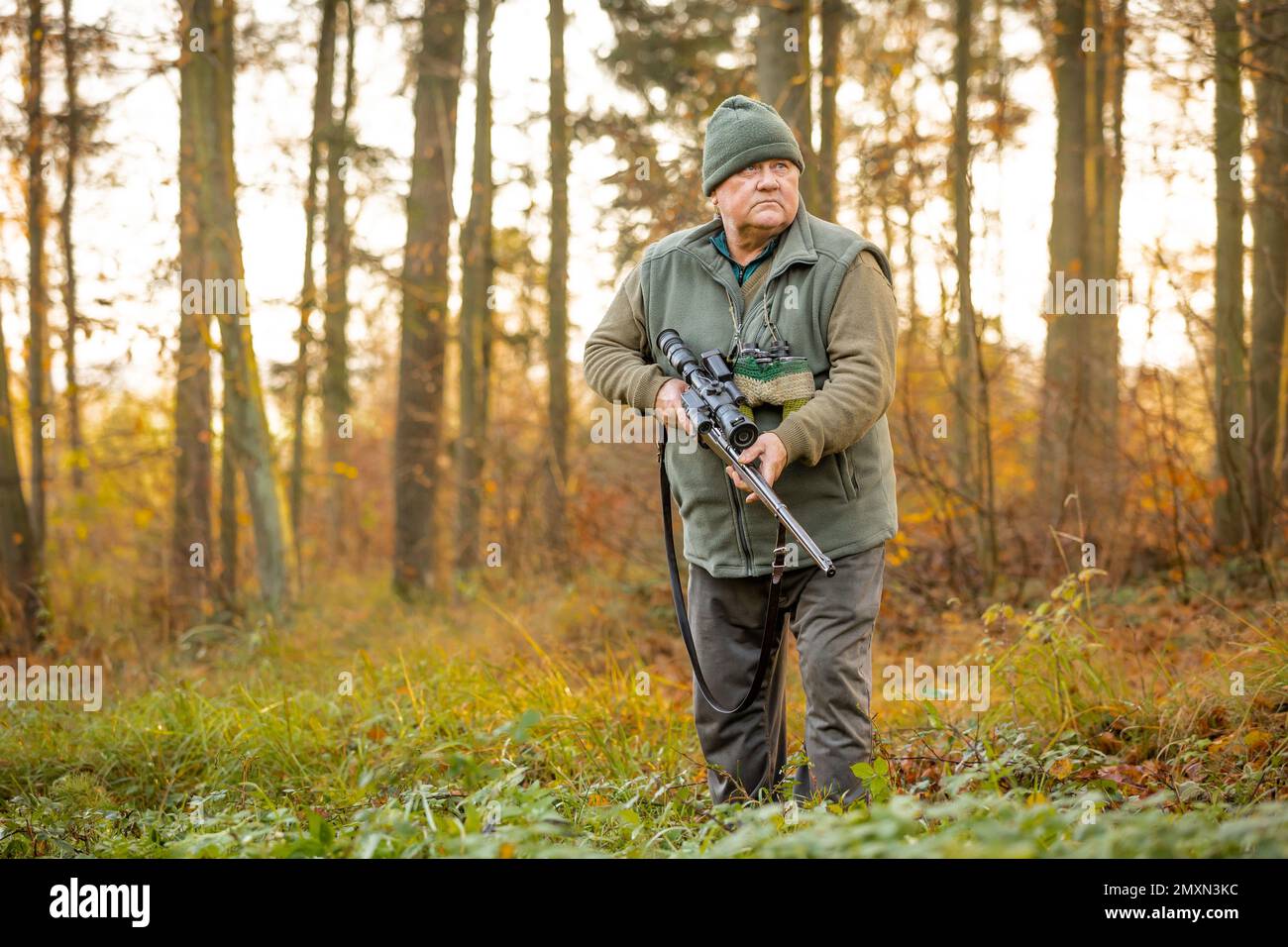 Portrait of hunter or ranger with a hunting gun and hunting form to ...